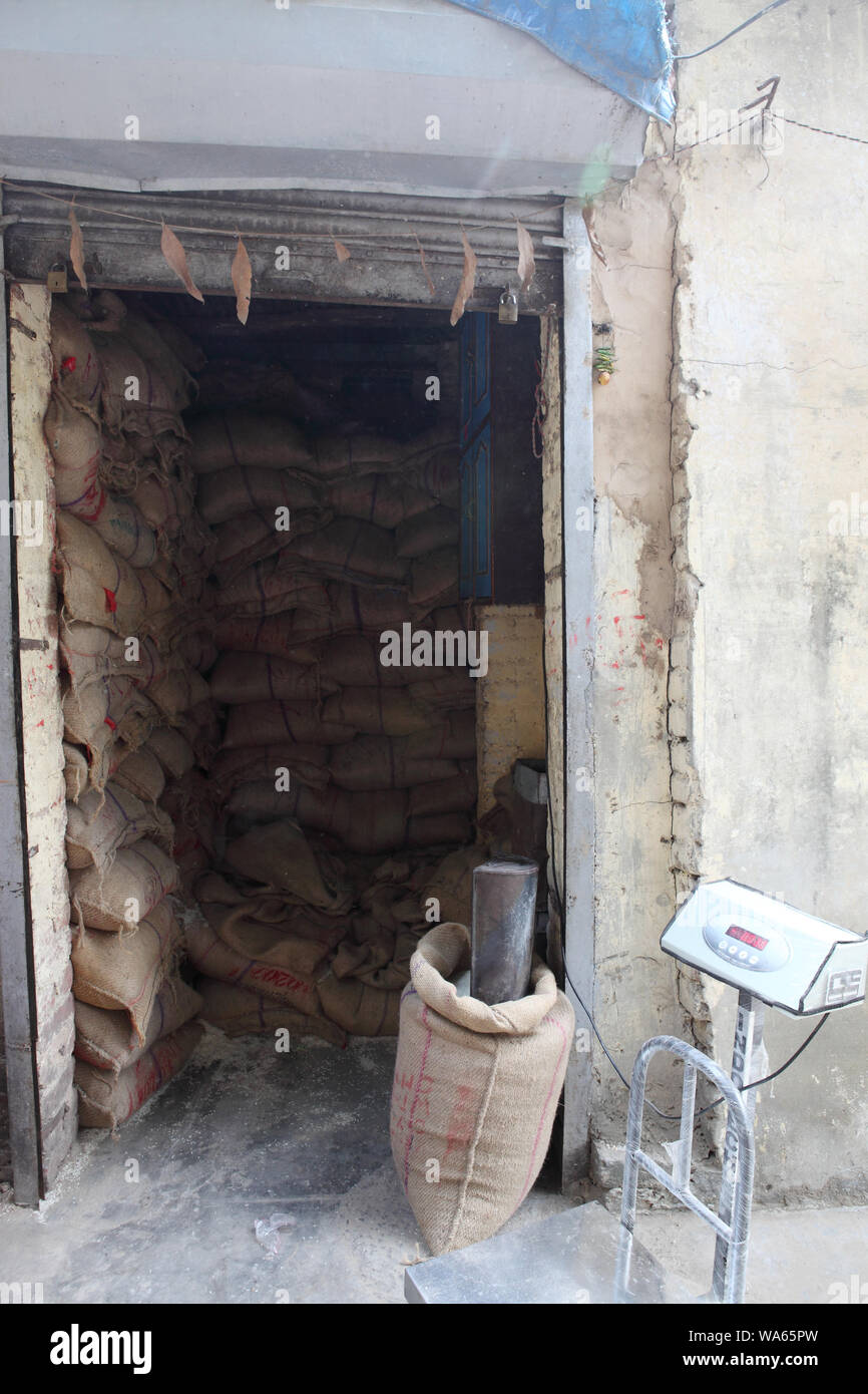 Warehouse stacked with sacks Stock Photo - Alamy