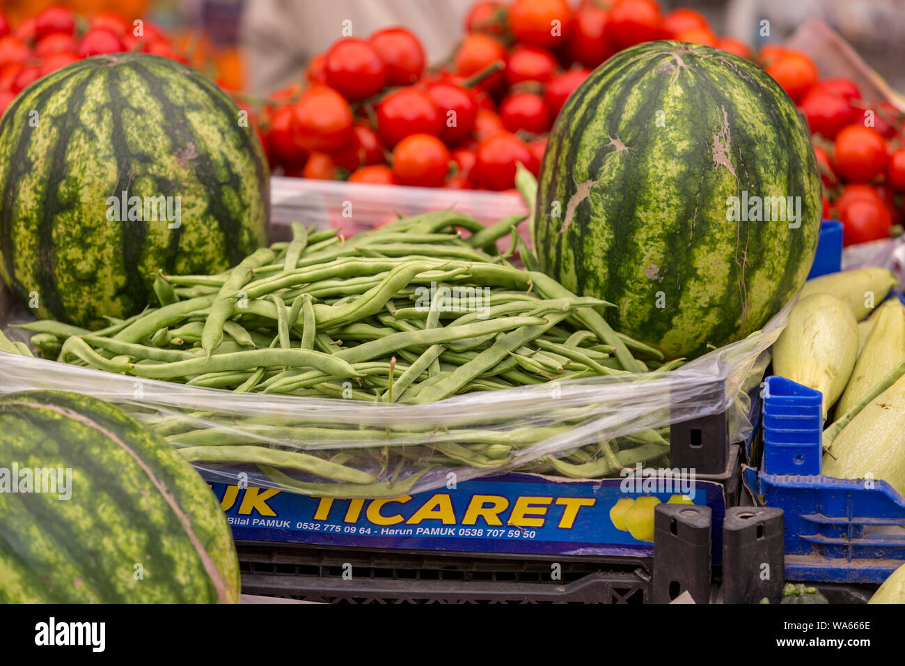 Watermelons, beans, and tomatoes at a market Stock Photo - Alamy