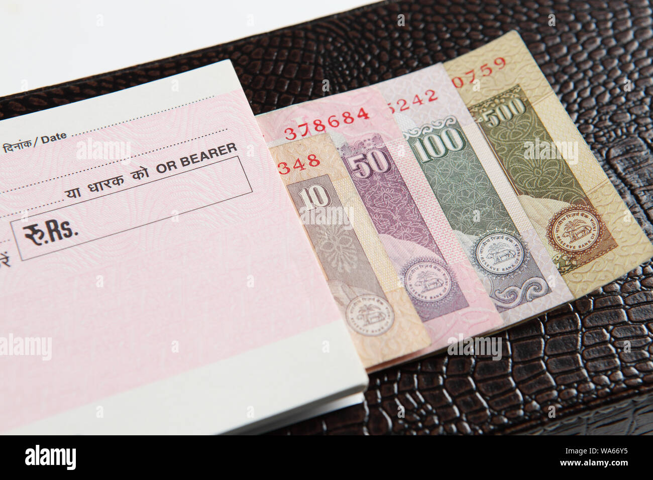 Indian rupees with a cheque book Stock Photo - Alamy