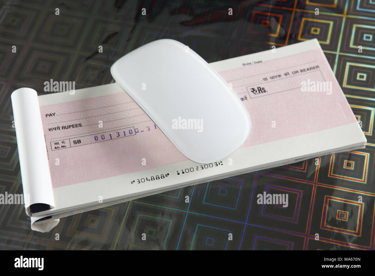 Computer mouse on a check book Stock Photo - Alamy