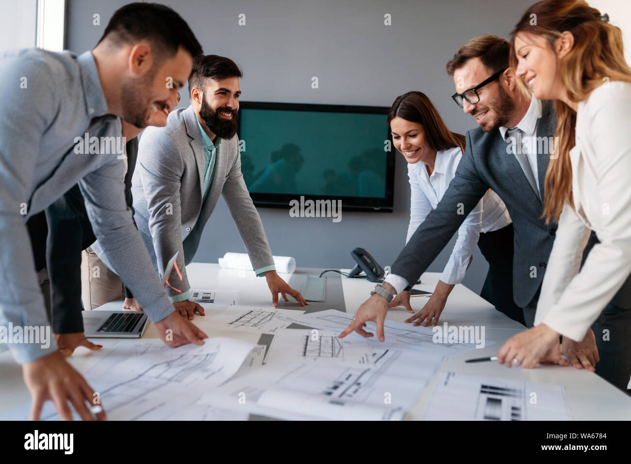 Group of architects and business people working together and ...