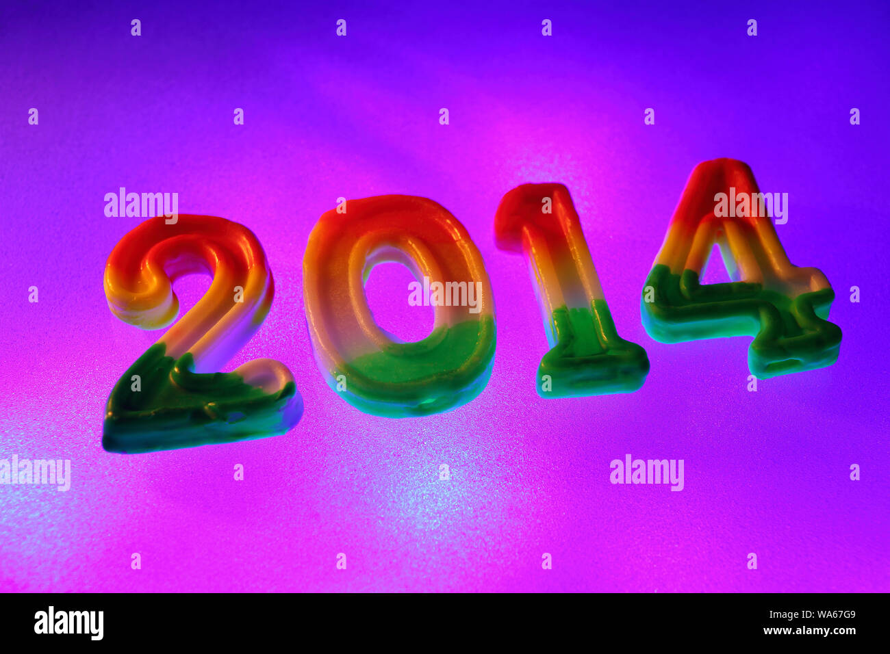 Candle representing 2014 year isolated on purple background Stock Photo ...