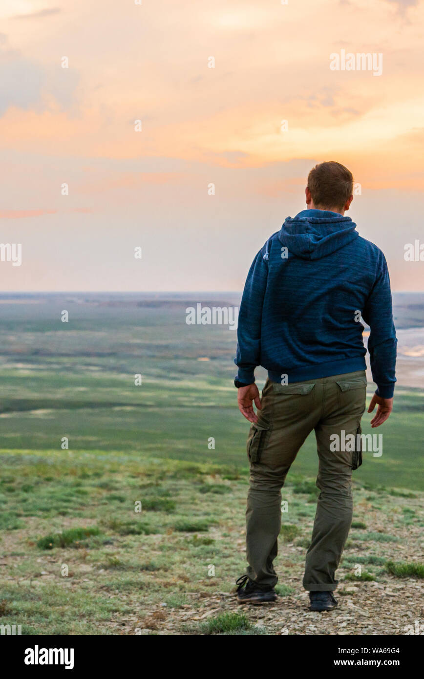 Back view young male hiker in steppe in natural reserve Stock Photo - Alamy