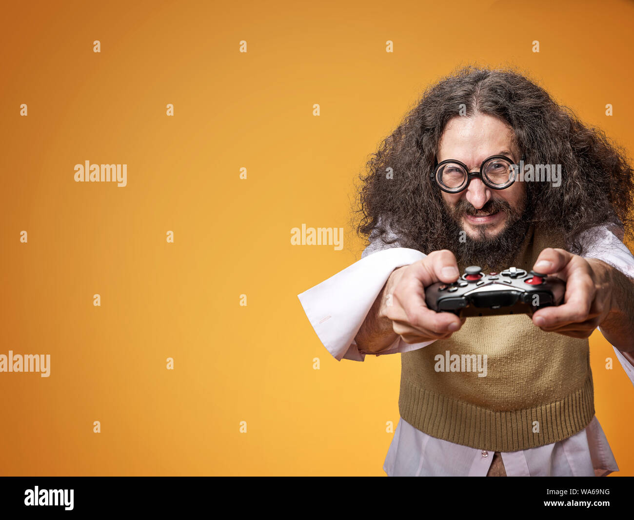 Funny portrait of a slim nerd playing video game Stock Photo - Alamy