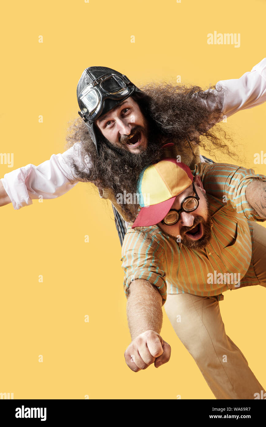 Funny portrait of two clever friends acting flying Stock Photo - Alamy