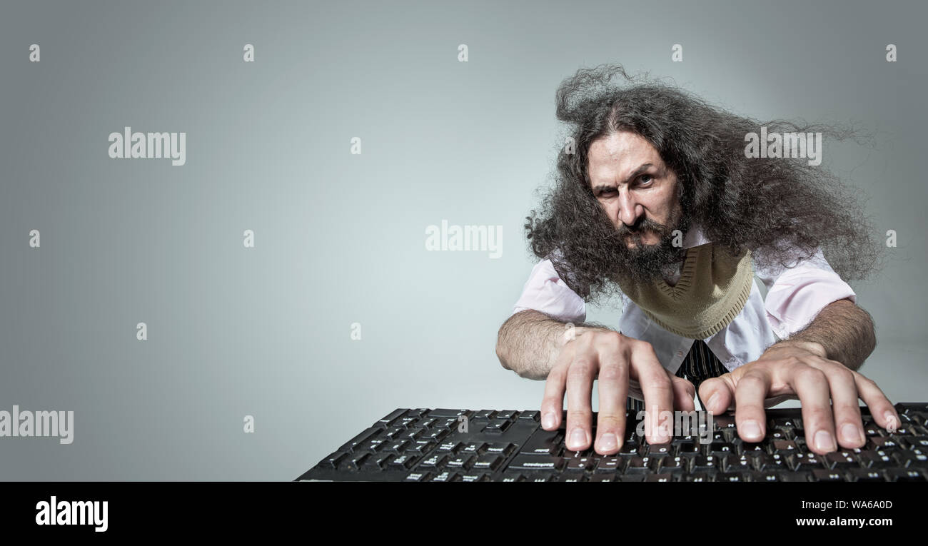 Funny portrait of a freaky nerd working with a computer Stock Photo - Alamy