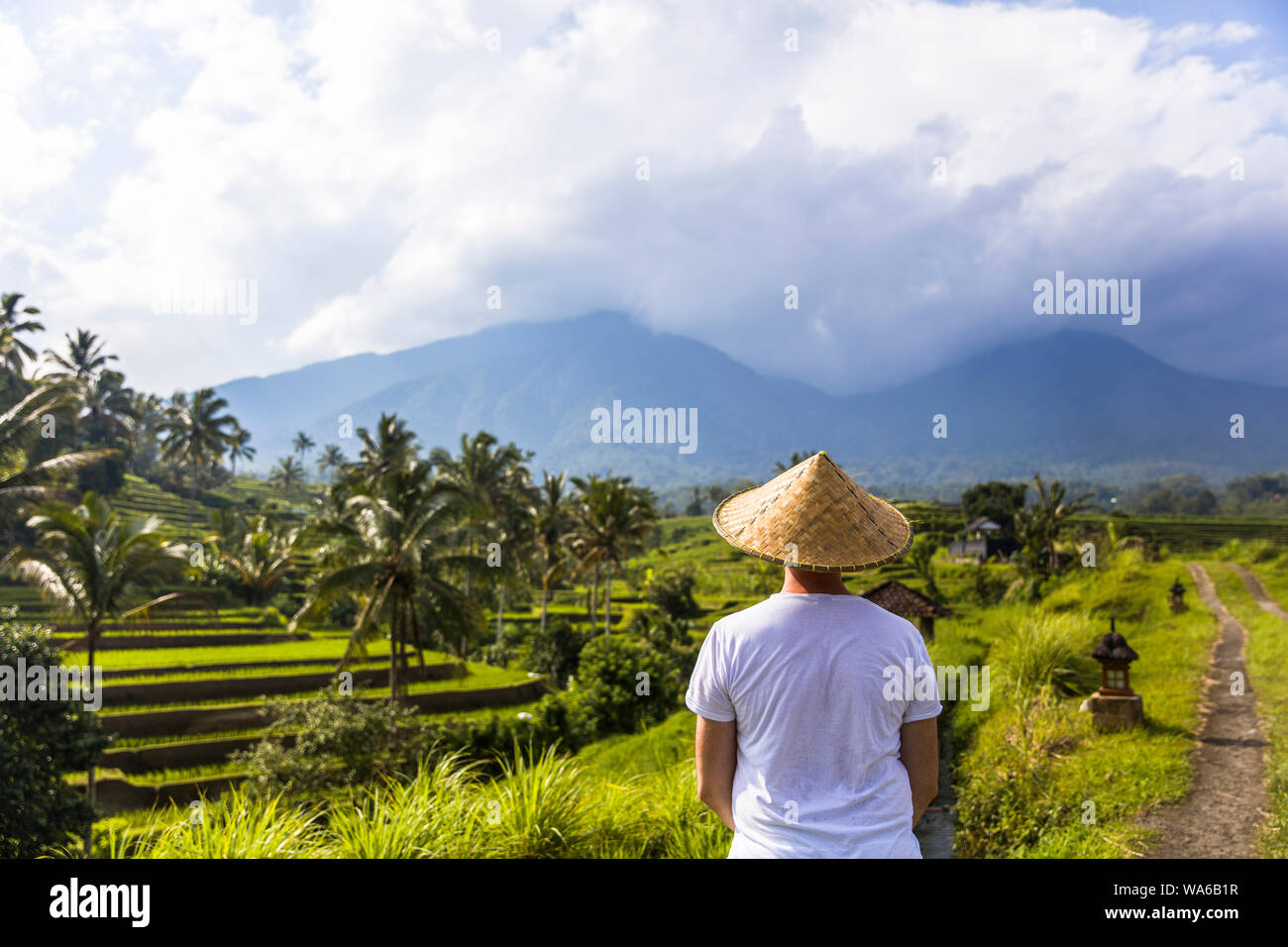 Man with traditional balinese cap at rice fields of Jatiluwih in ...