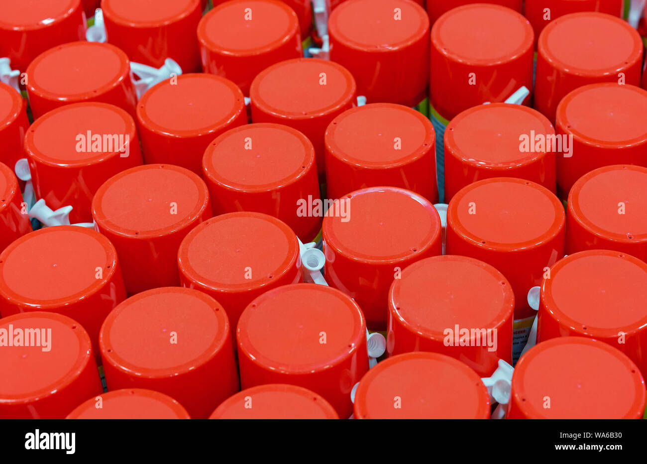 Red caps on cylinders with mounting foam Stock Photo - Alamy