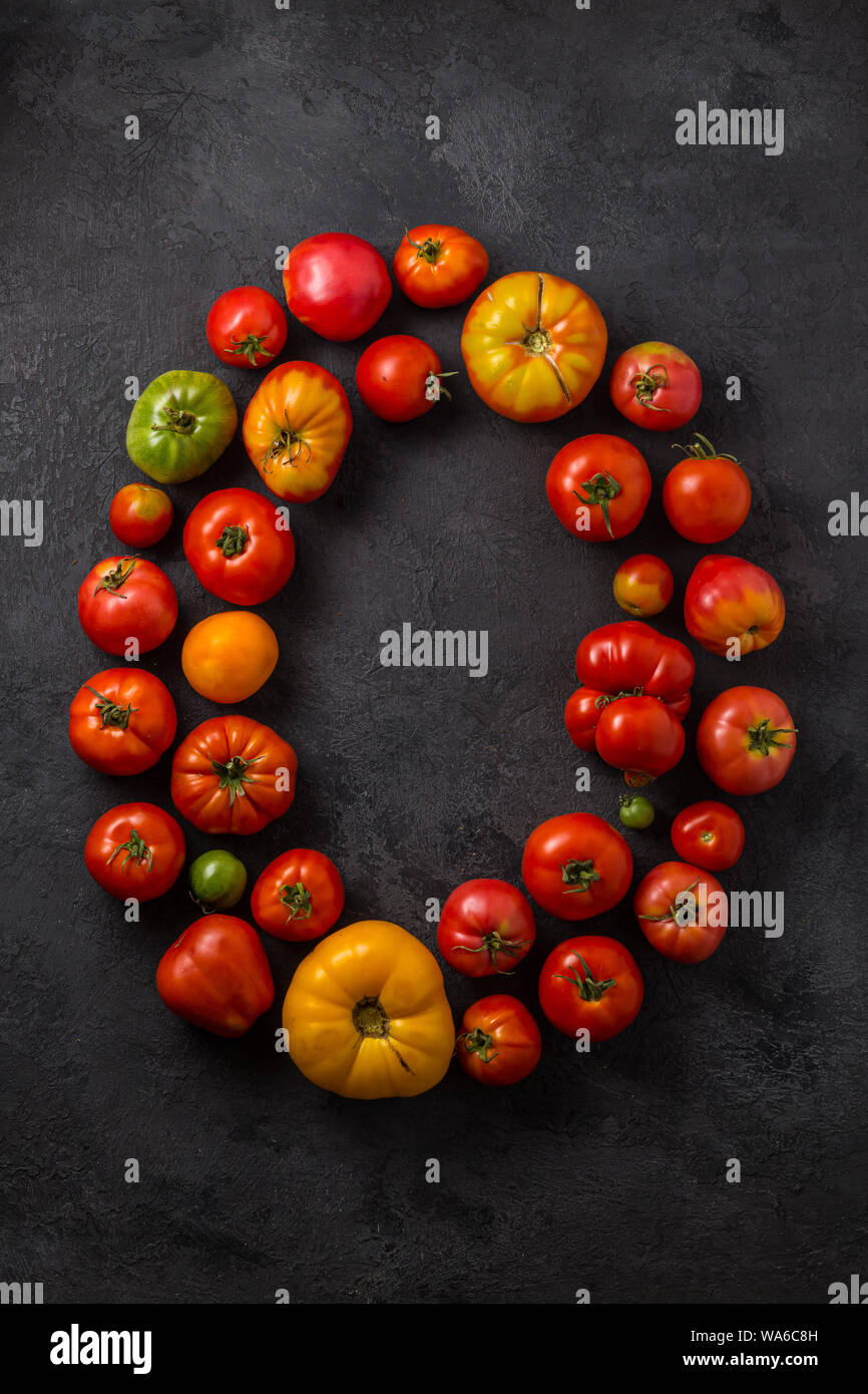 Tomato word made with ripe tomatoes on a black background, creative ...