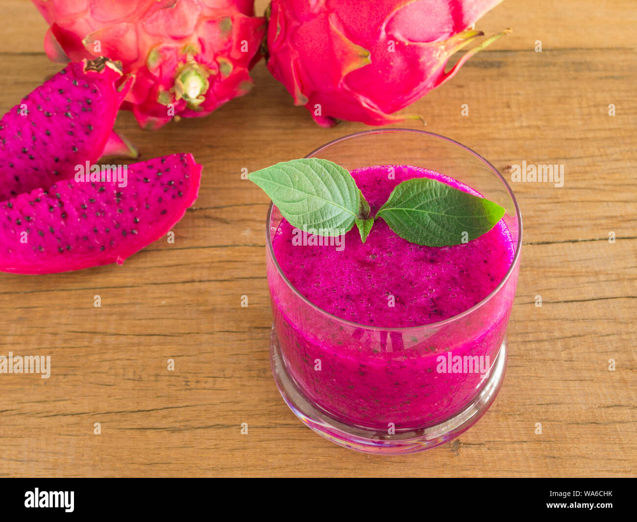 fresh red dragon fruit juice and sliced on wood background Stock Photo ...