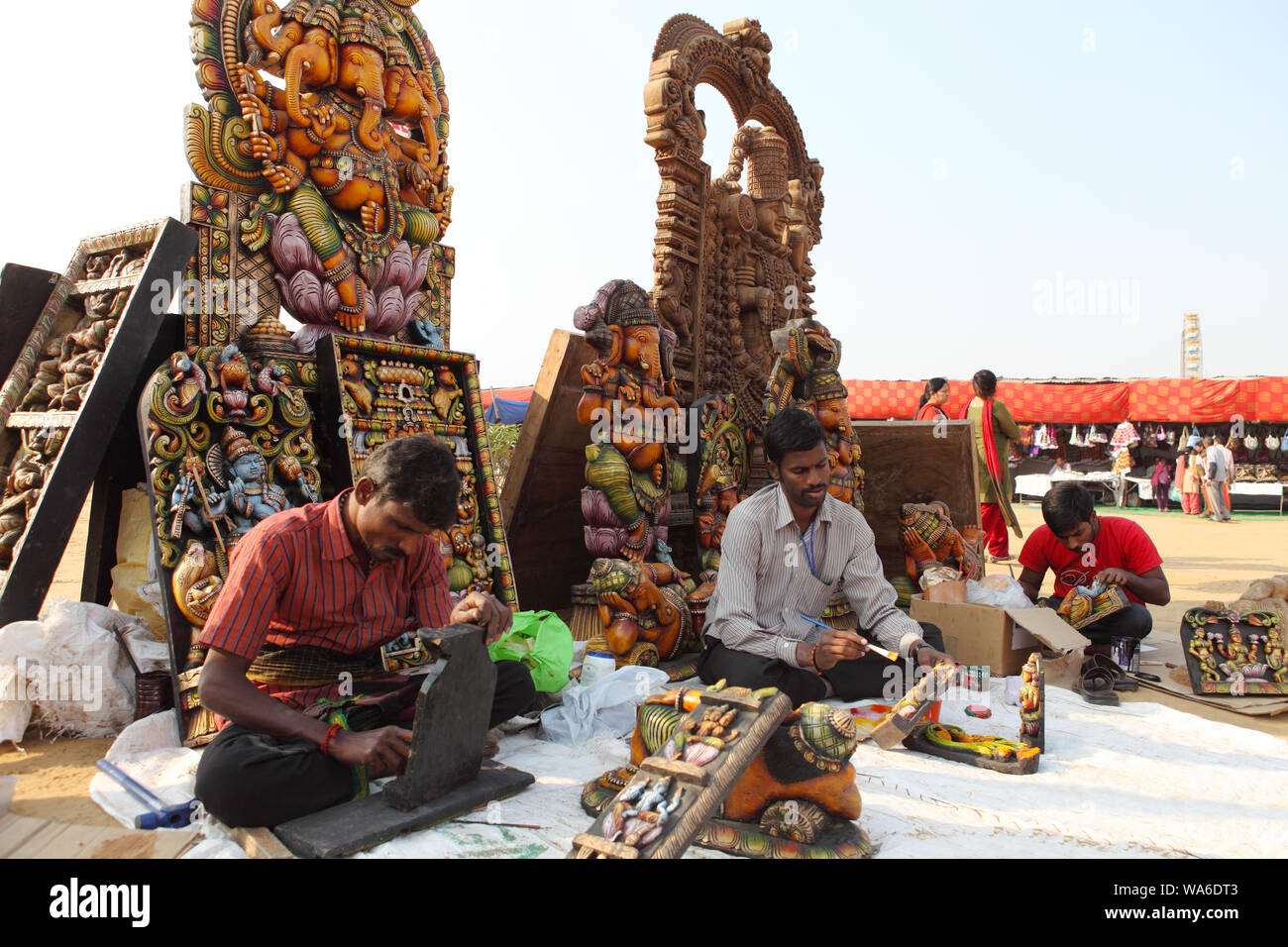 Male artists painting statues of gods at Mela, Gurgaon, Haryana, India ...