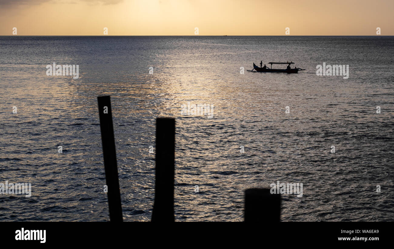 A traditional small fishing boat sailing in the ocean Stock Photo - Alamy