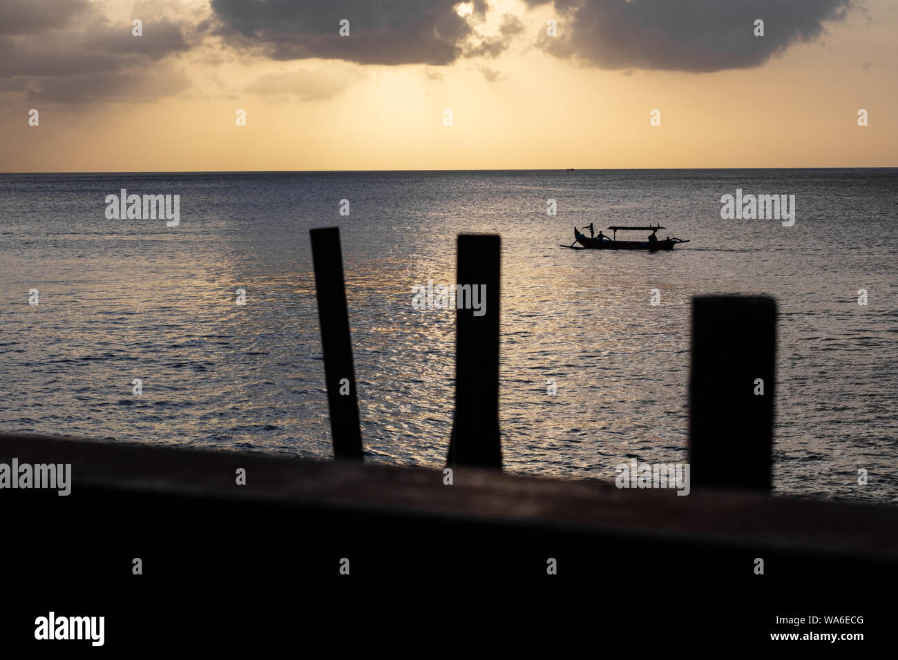 A traditional small fishing boat sailing in the ocean Stock Photo - Alamy