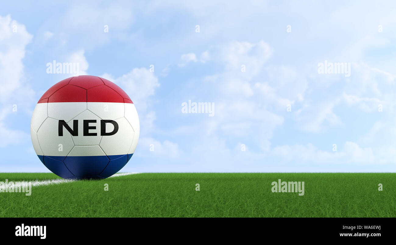 Soccer ball in Netherlands national colors on a soccer field. Copy ...