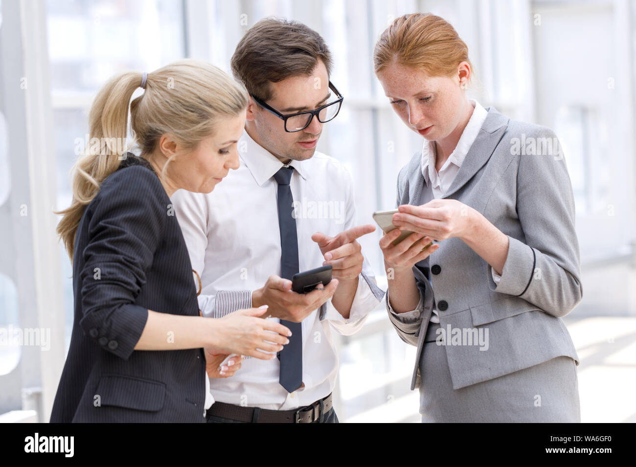 People in modern office mobile phones hi-res stock photography and ...