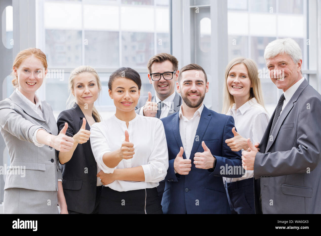 Portrait business people team showing thumbs up , office staff standing ...