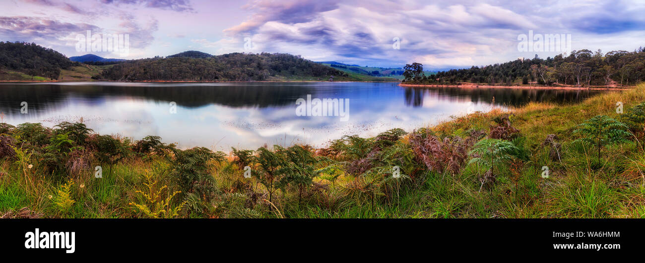 Still quiet Lyell lake surrounded by hill ranges and gum tree woods in ...