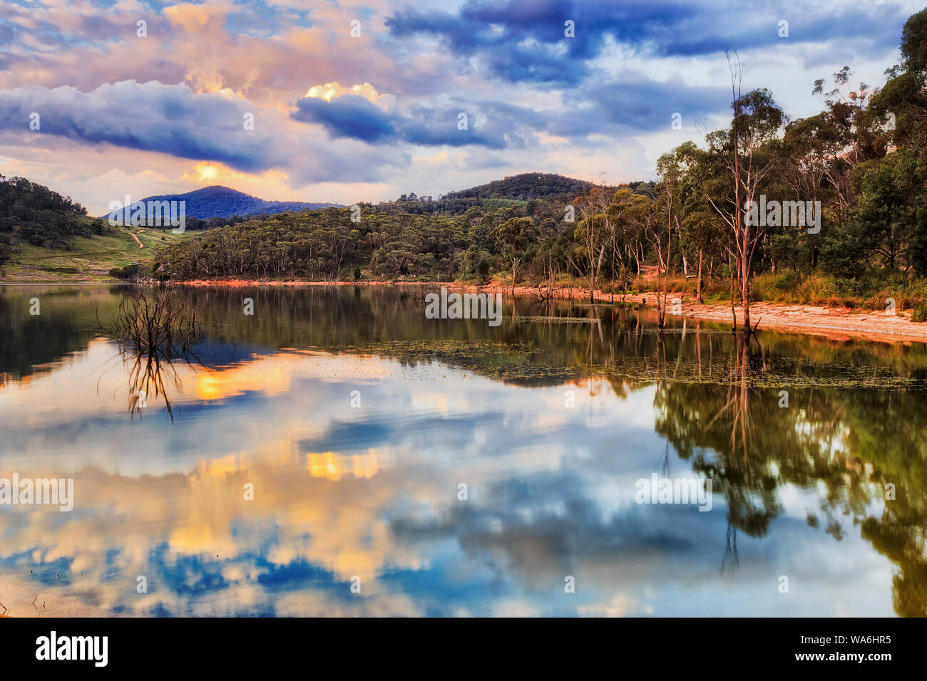 Colourful sunset over Lake Lyell still waters reflecting with ...