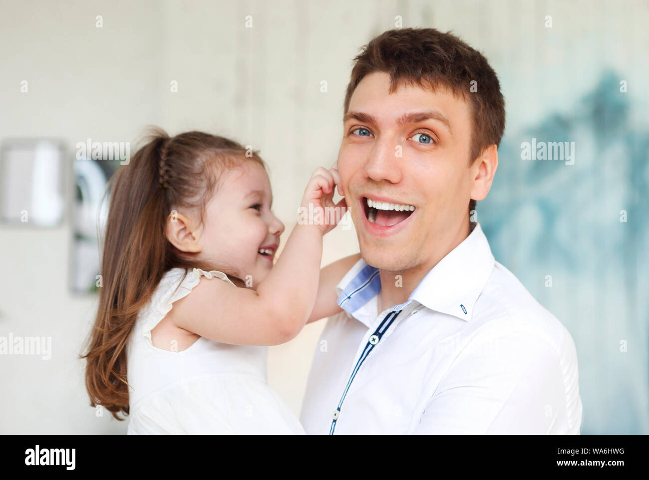 Adorable little daughter embracing father having fun Stock Photo - Alamy