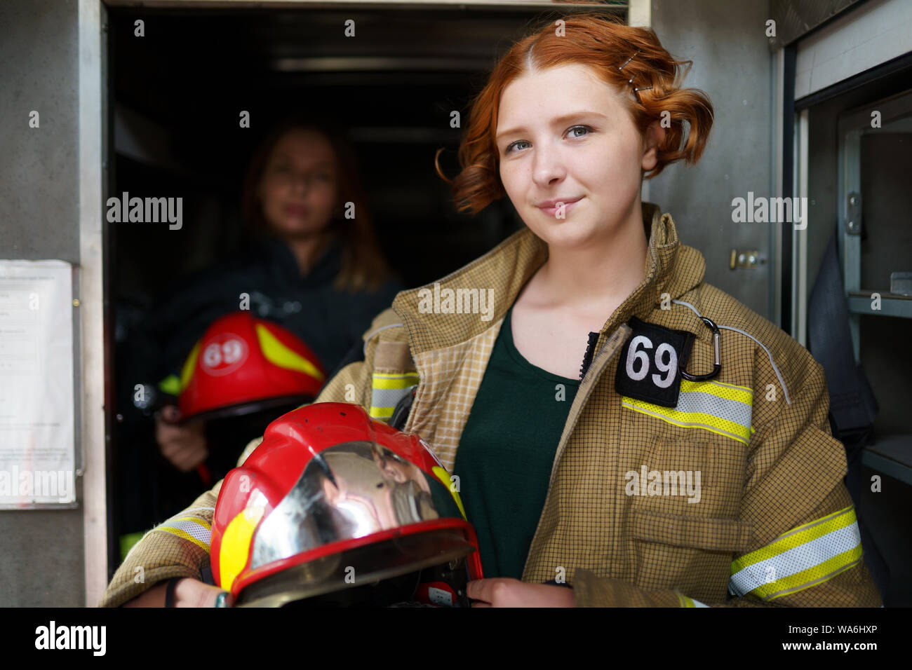 Photo of two female firefighters in fire truck Stock Photo - Alamy
