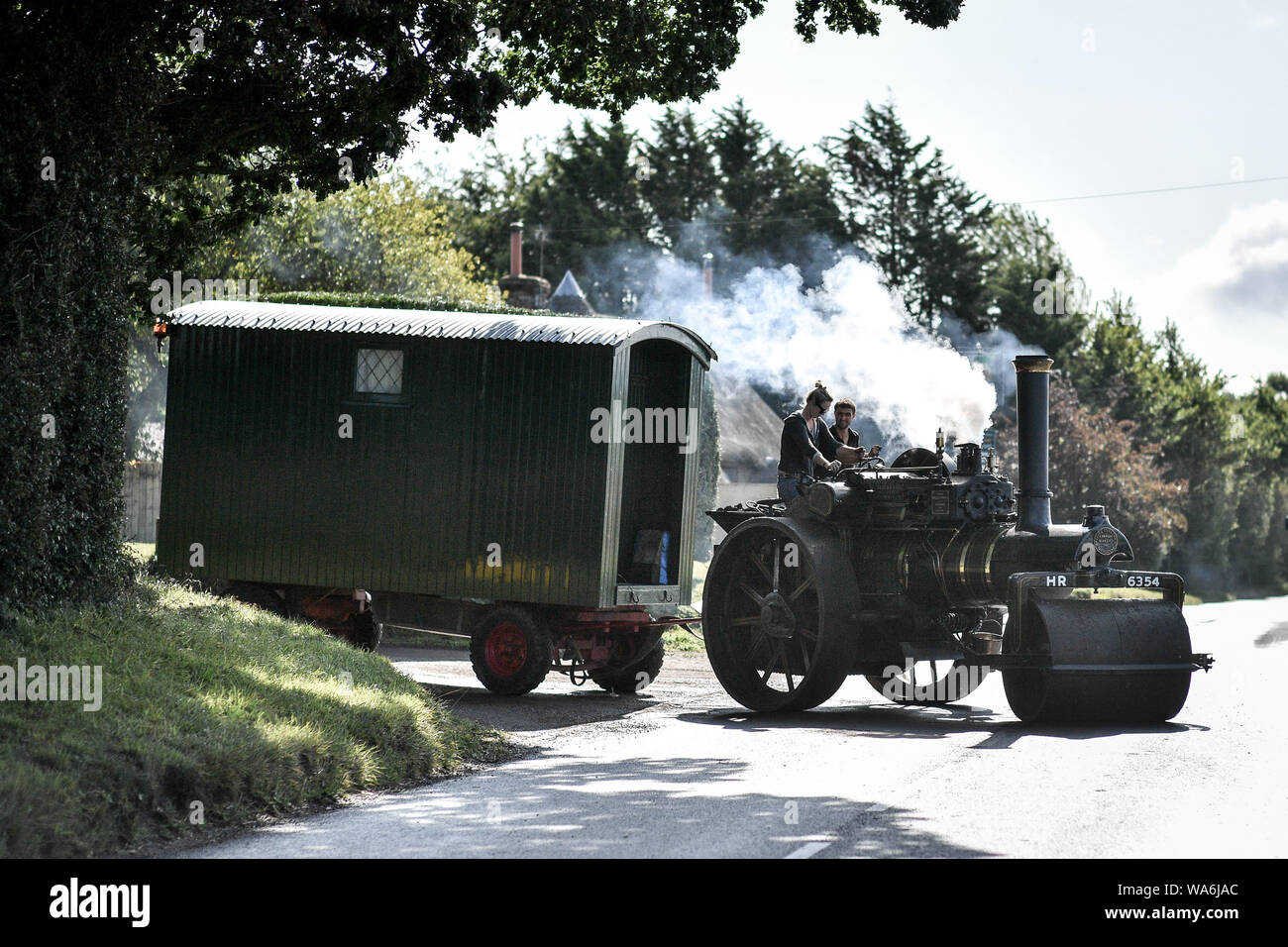 A traction engine steams up as it leaves Drusilla's Inn, near Horton ...