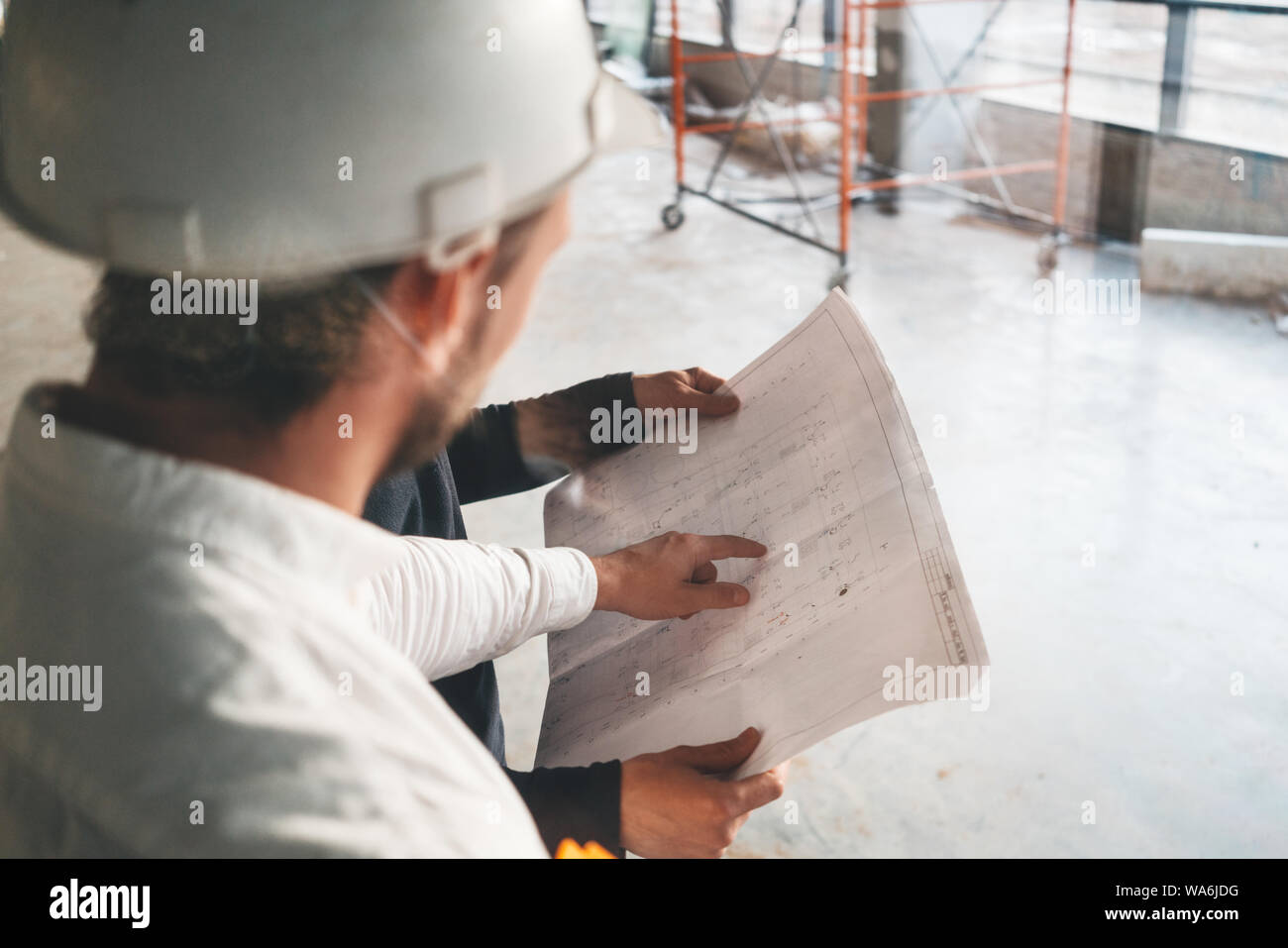 Close up view on construction drawing in engineer hands. Builder ...