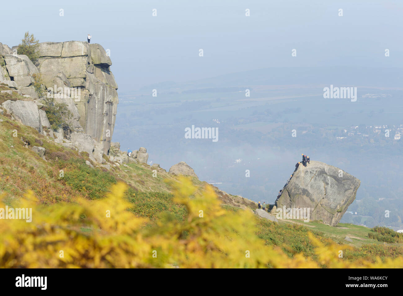 View of Cow and Calf Rocks, with climbers stood on Cow rock, Ilkley ...
