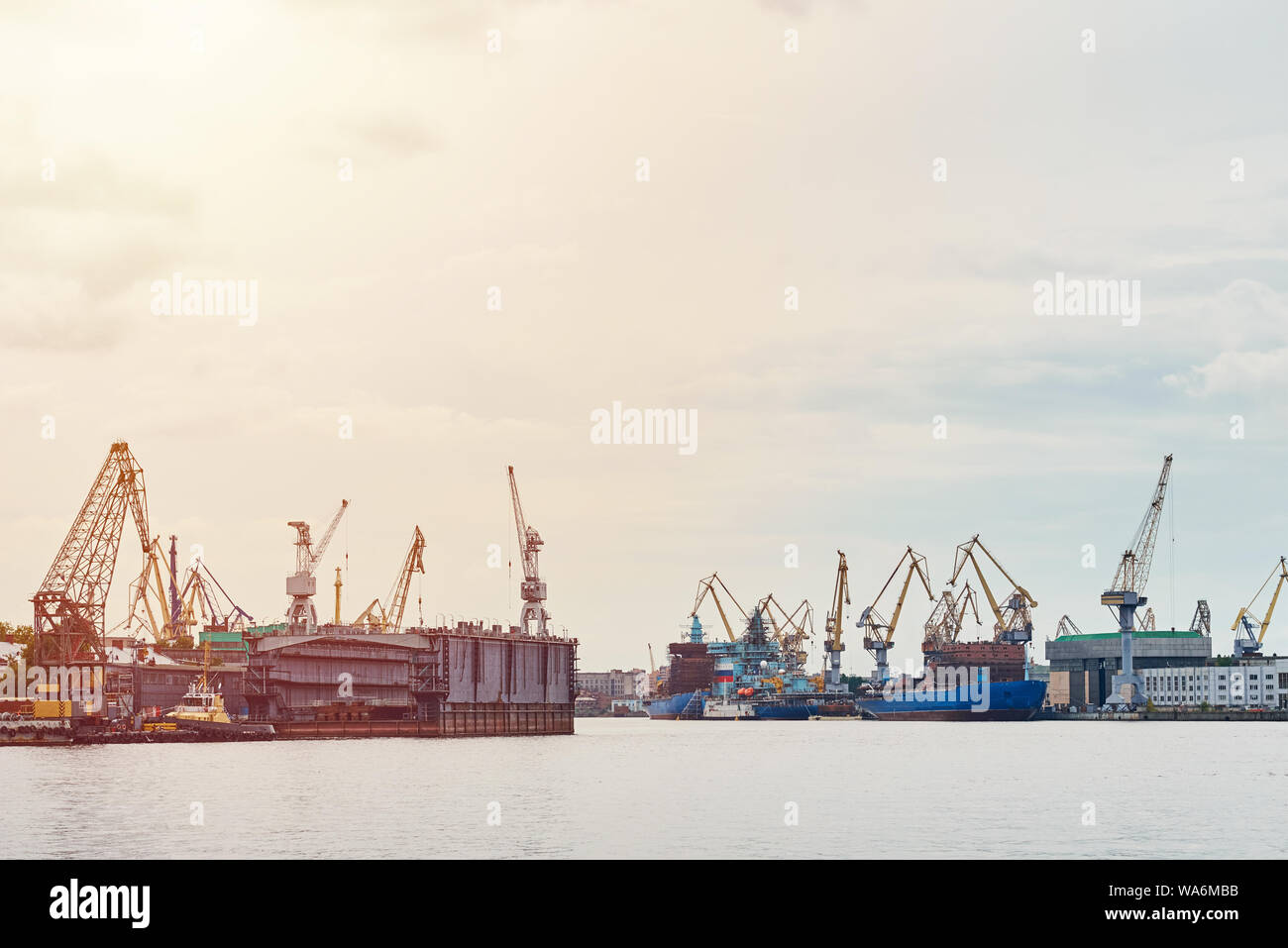 working crane bridge in shipyard and cargo ships in port Stock Photo ...