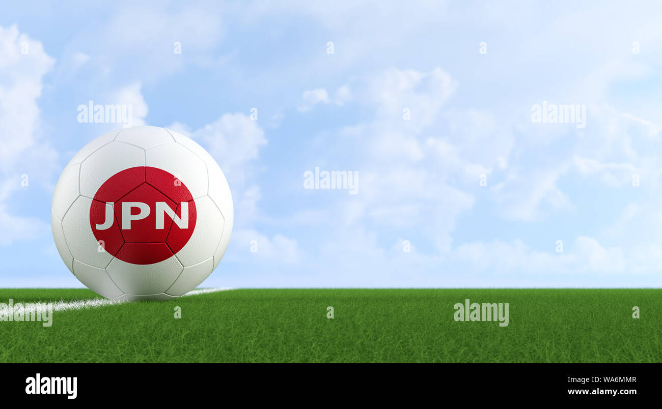 Soccer ball in Japan national colors on a soccer field. Copy space on ...