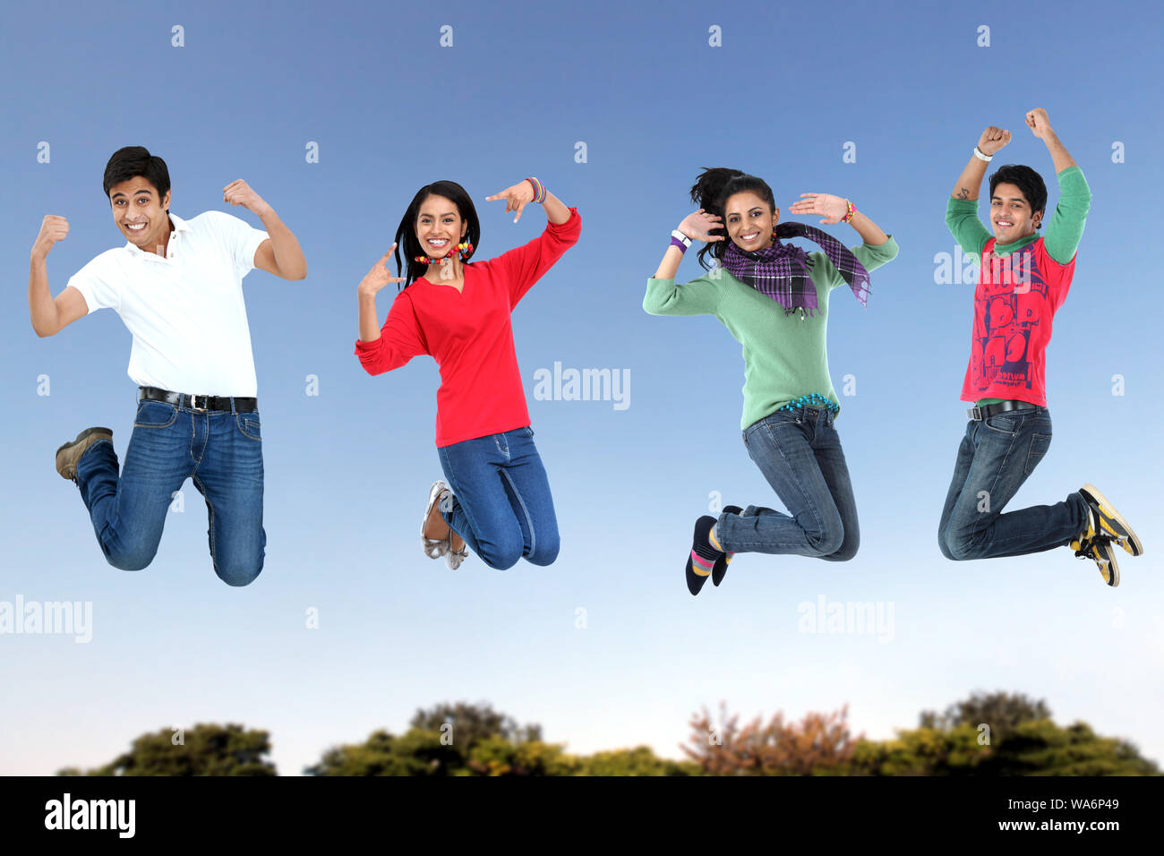 Group of friends jumping in air and smiling Stock Photo - Alamy