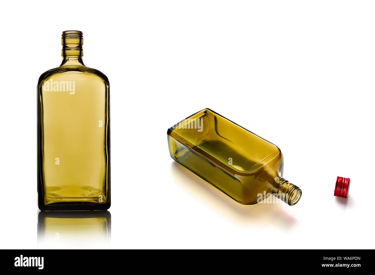 Empty alcohol bottles of different color glass. White isolate ...