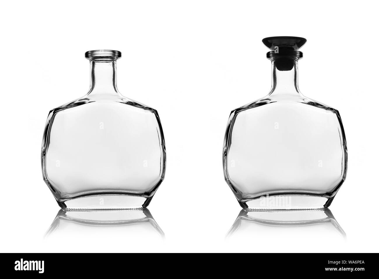 Empty alcohol bottles open and closed by transparent glass. White ...