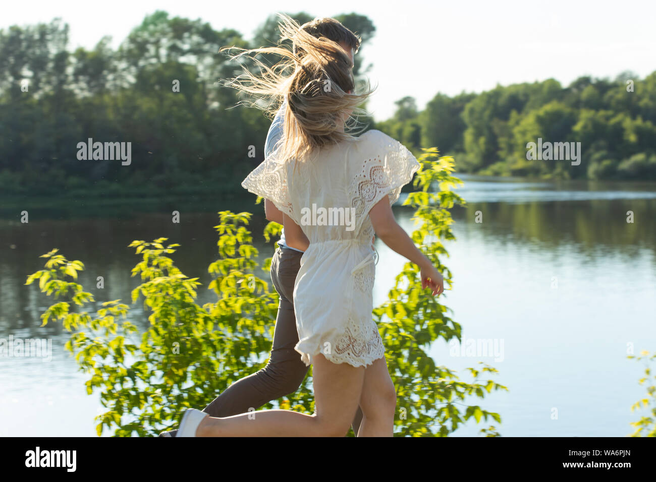 Love and relationship concept - The happy man and woman running in a ...