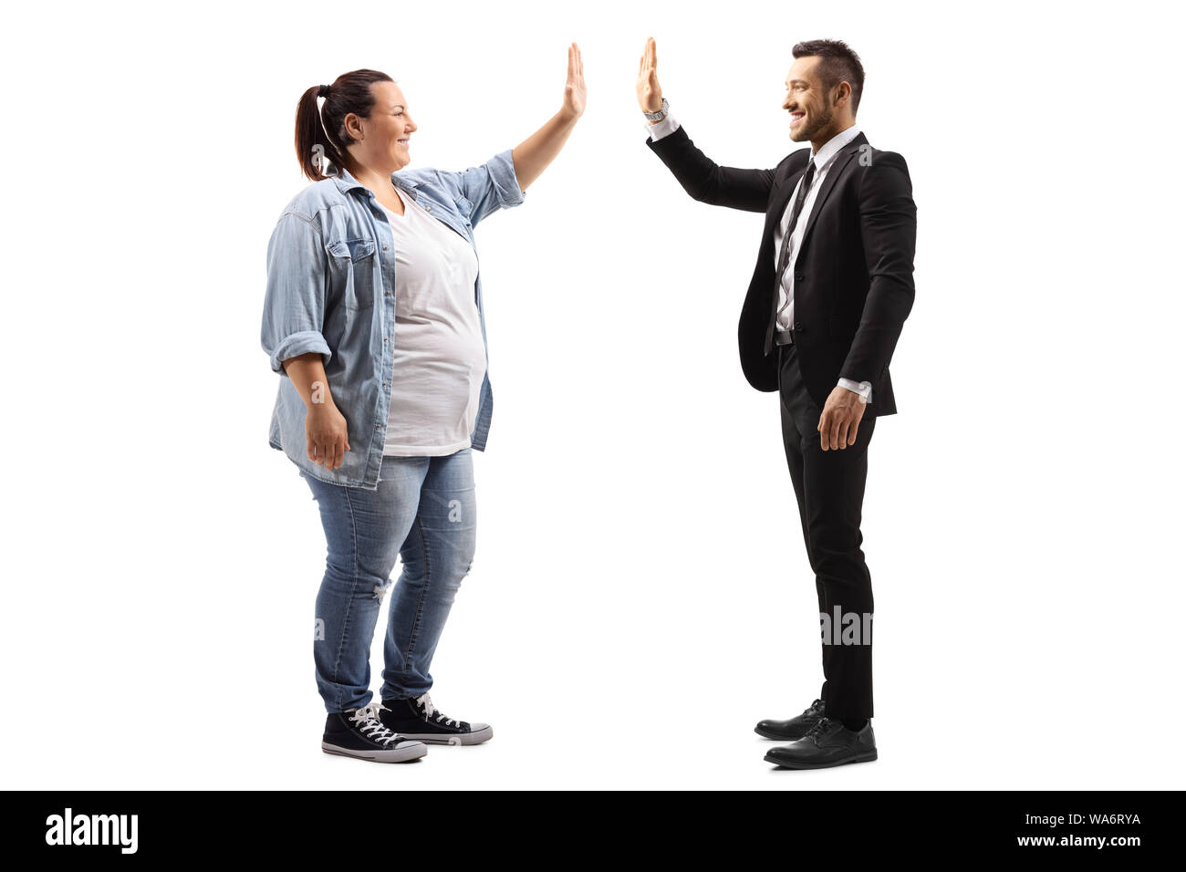 Full length profile shot of an overweight woman high-fiving a young man ...