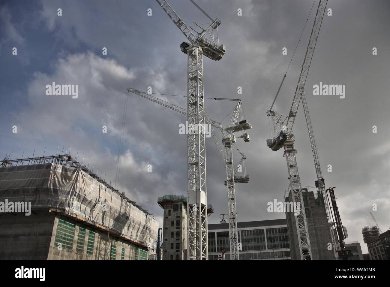 Low angle shot of cranes in an architectural place Stock Photo - Alamy