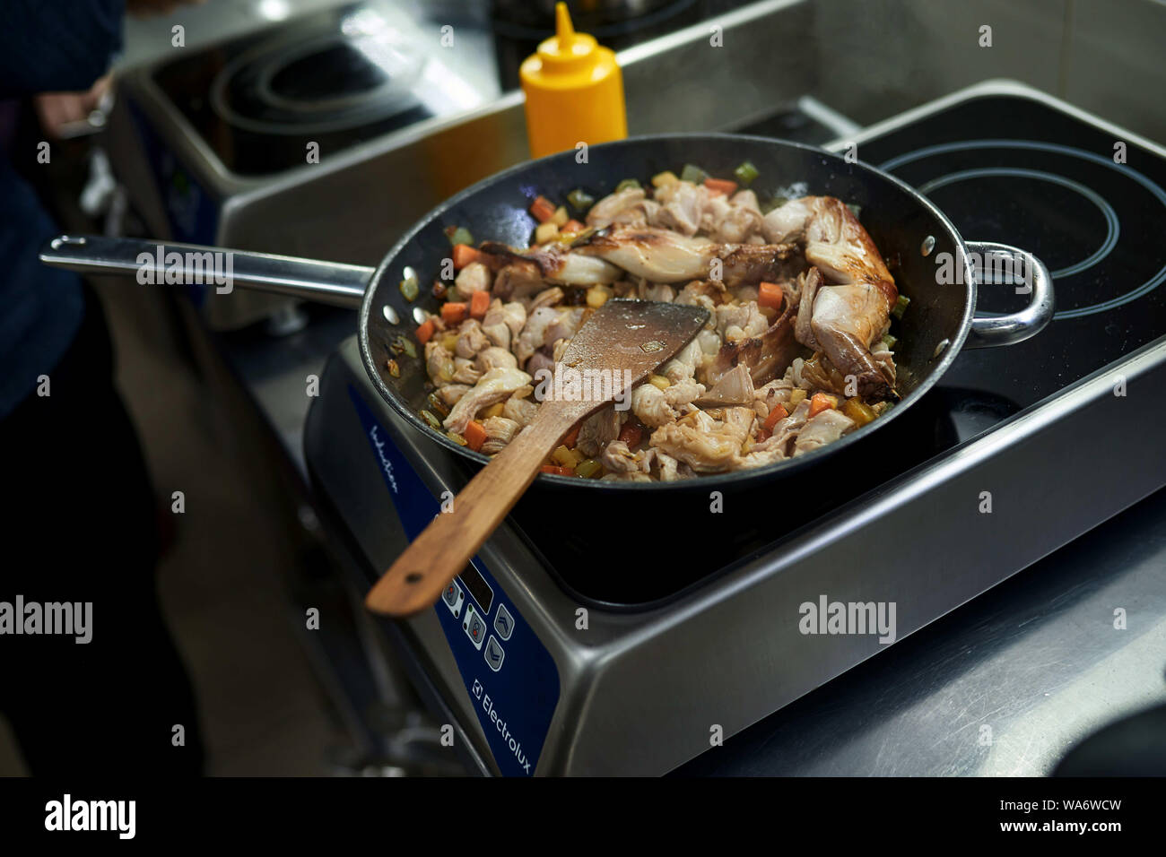 cooking in a pan with stove and cook Stock Photo - Alamy