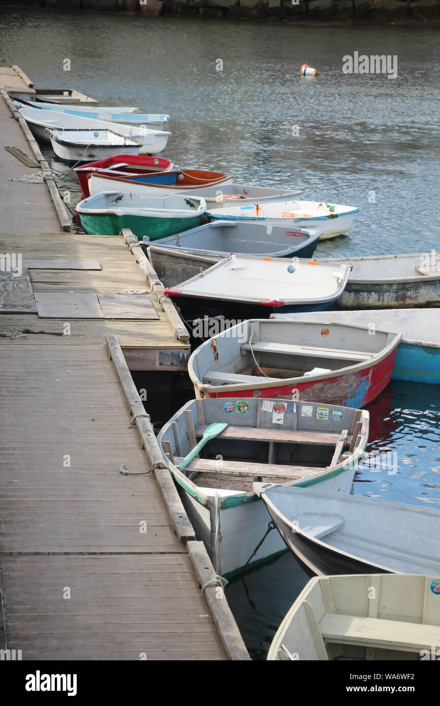colorful tender boats tied to a weathered dock in calm waters Stock ...