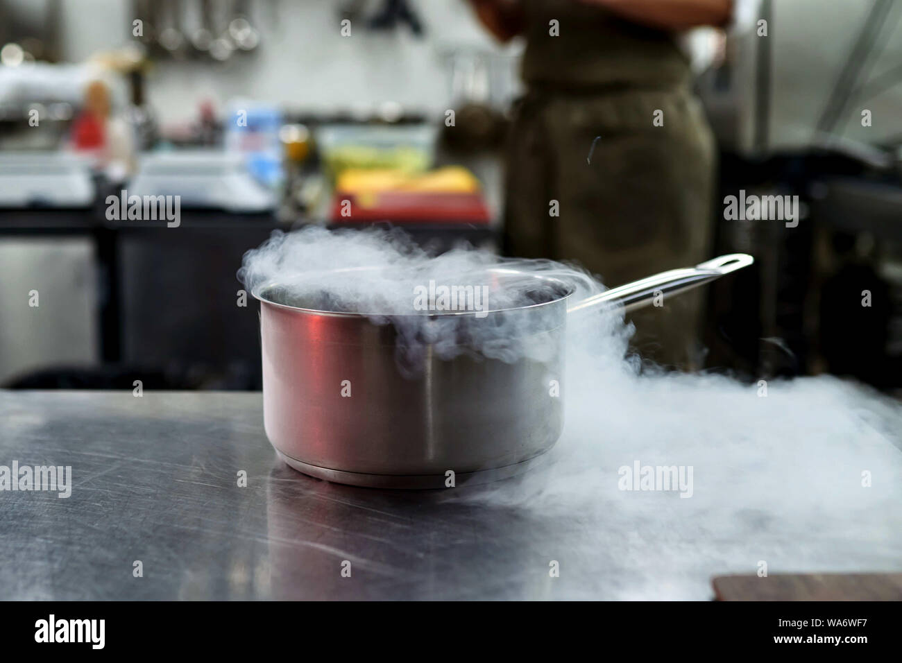 Liquid Nitrogen in a pan. Cooking. Steam. Cook. Against the background ...