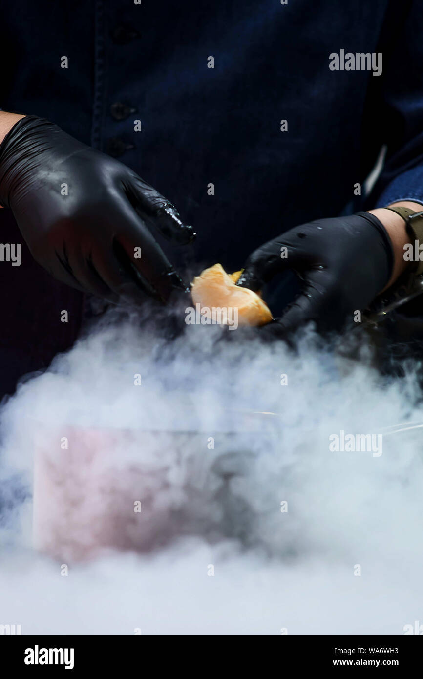 Liquid Nitrogen in a pan. Cooking. Steam. Cook. Against the background ...