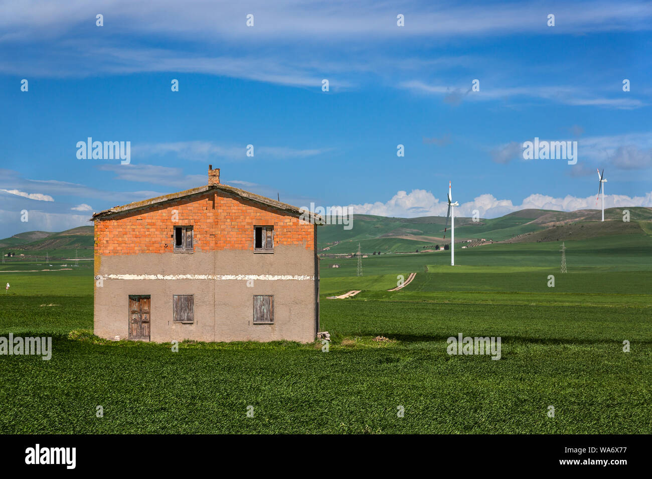 Old House in Field with Wind Turbines Stock Photo - Alamy