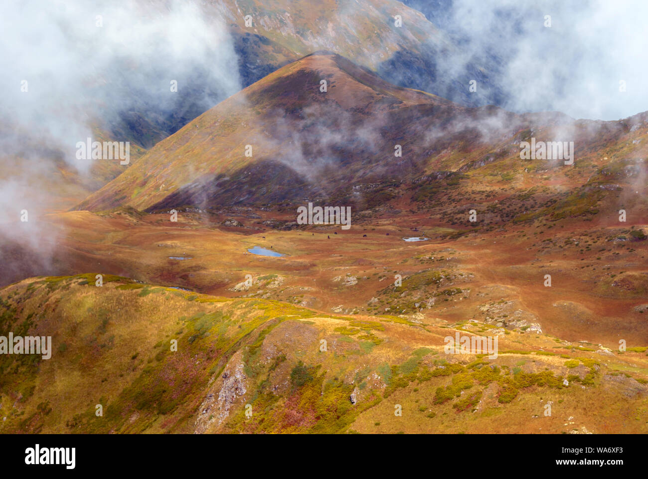 clouds-covered high mountain valley with a lake, aerial view Stock ...