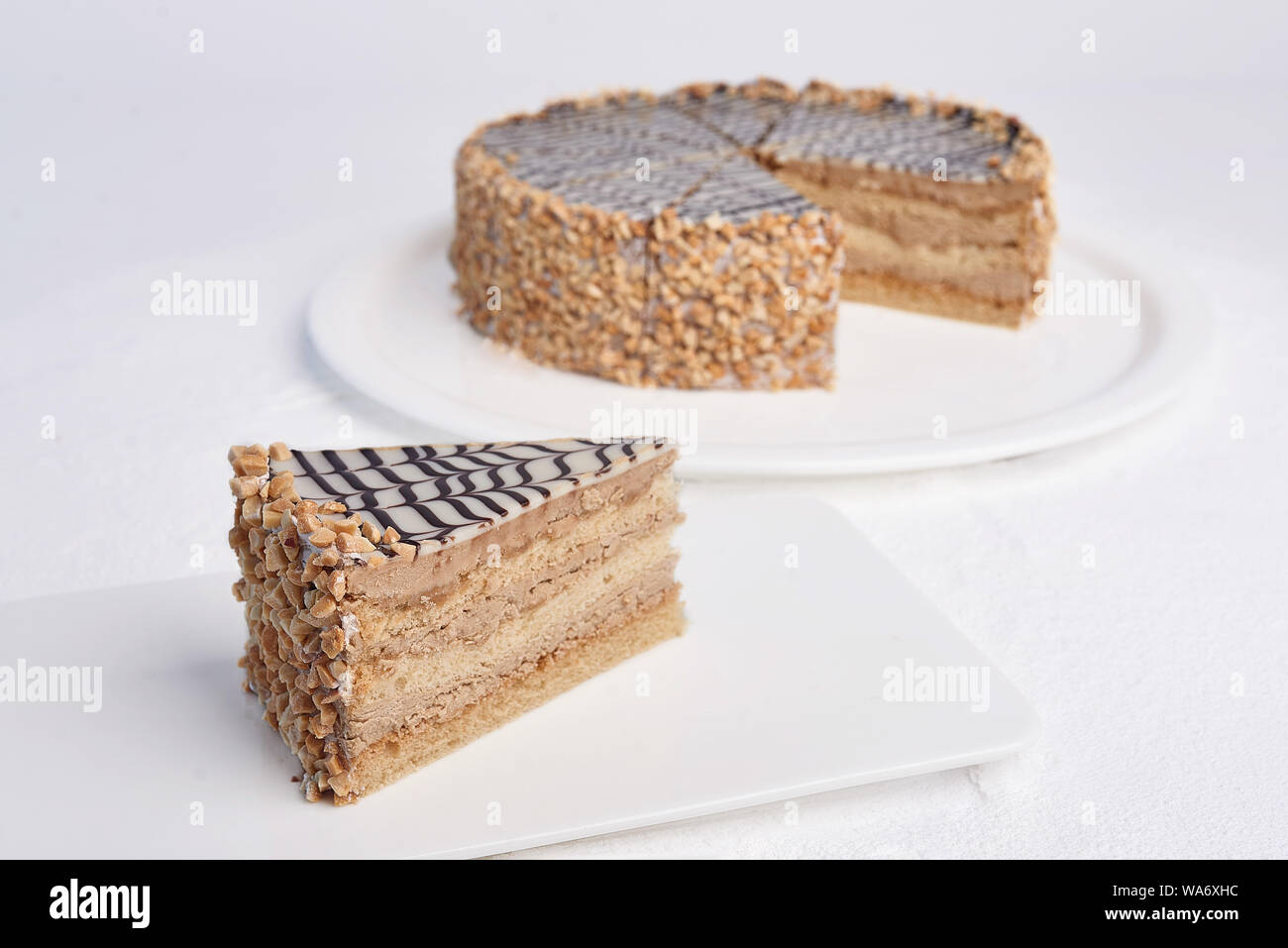 Tasty big piece of cake on a plate on a white background Stock Photo ...