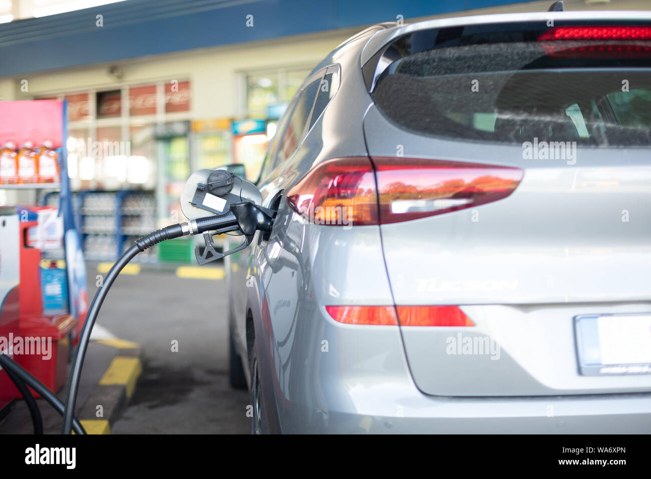 Refueling refilling car vehicle with fuel at refuel fuel gas pump ...