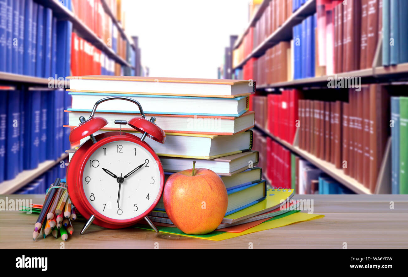 Education concept with stack of book in the very blurry library ...
