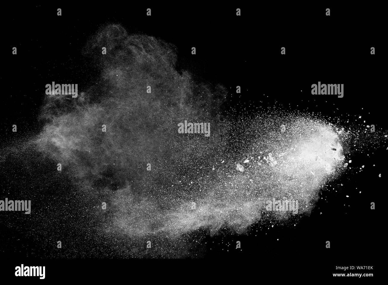 Bizarre forms of white powder explosion cloud against black background ...