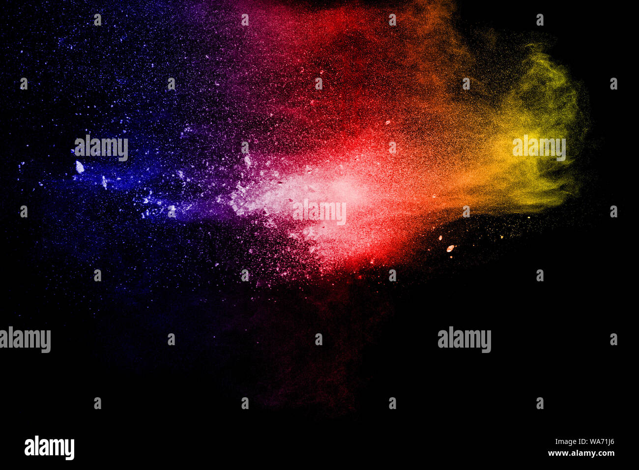 Multi color powder explosion on black background Stock Photo - Alamy