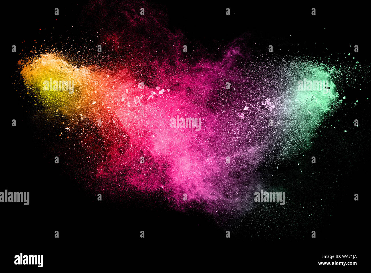 Multi color powder explosion on black background Stock Photo - Alamy