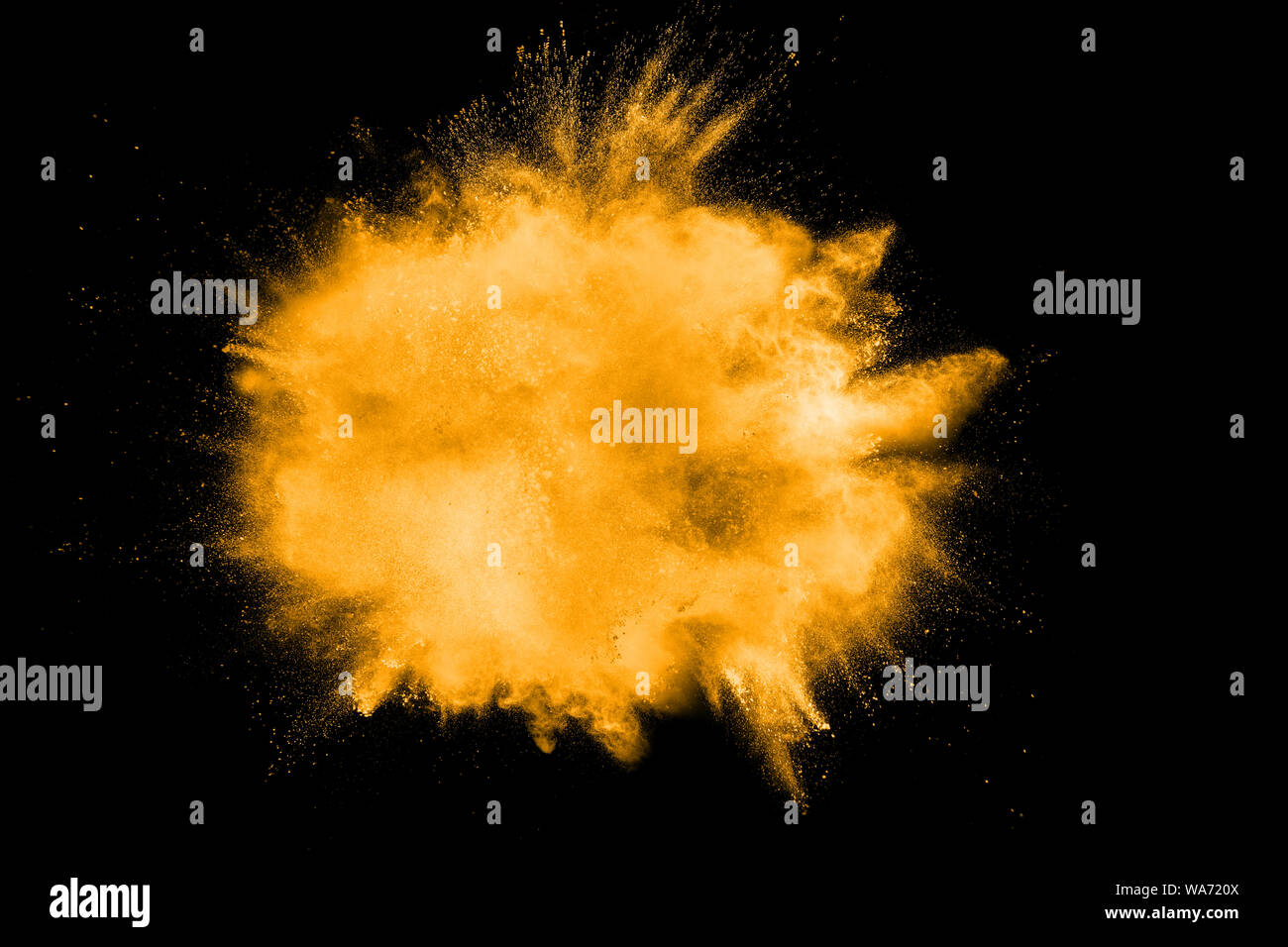 Abstract explosion of orange dust on white background. Freeze motion of ...