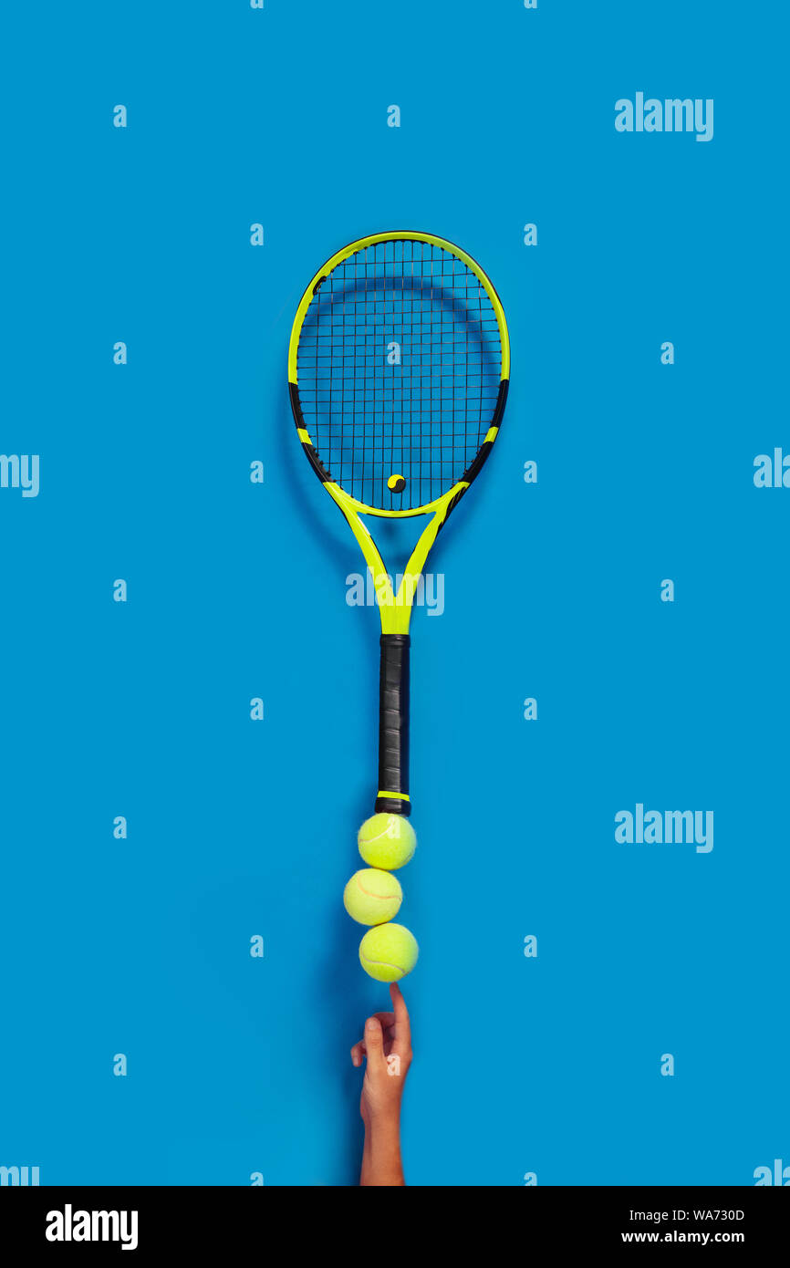 Sport. Tennis racket and balls balancing on a finger Stock Photo - Alamy