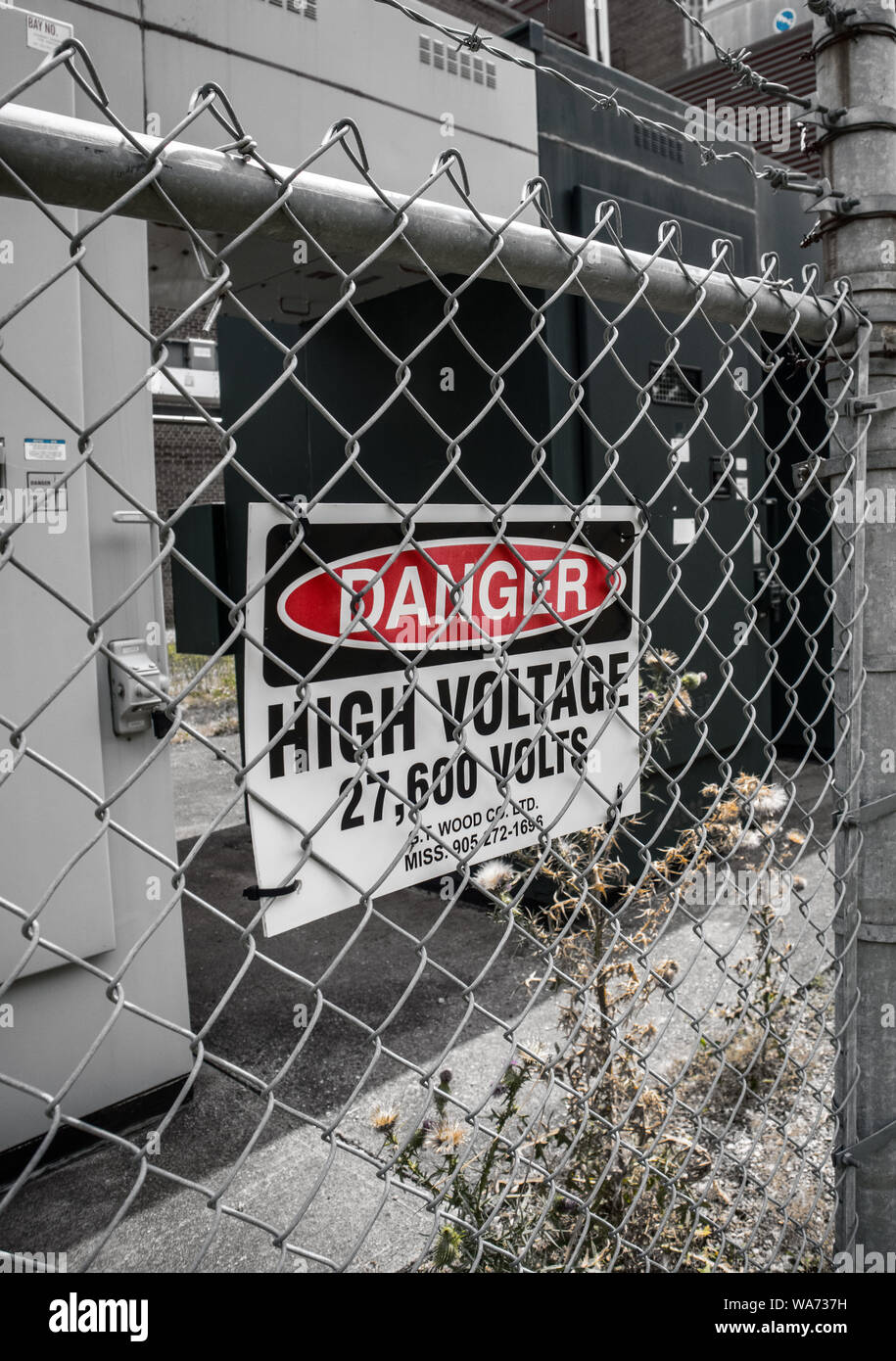 Behind the fences there is a high voltage apparatus. A DANGER sign ...